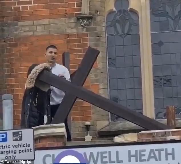 Church 'distressed' after vandal filmed trying to tear down cross ...