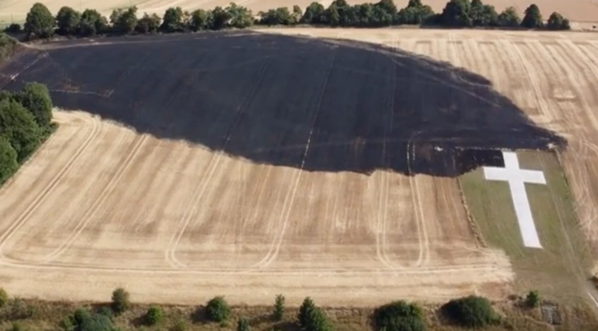 Memorial cross survives fire that swept through field during heatwave ...